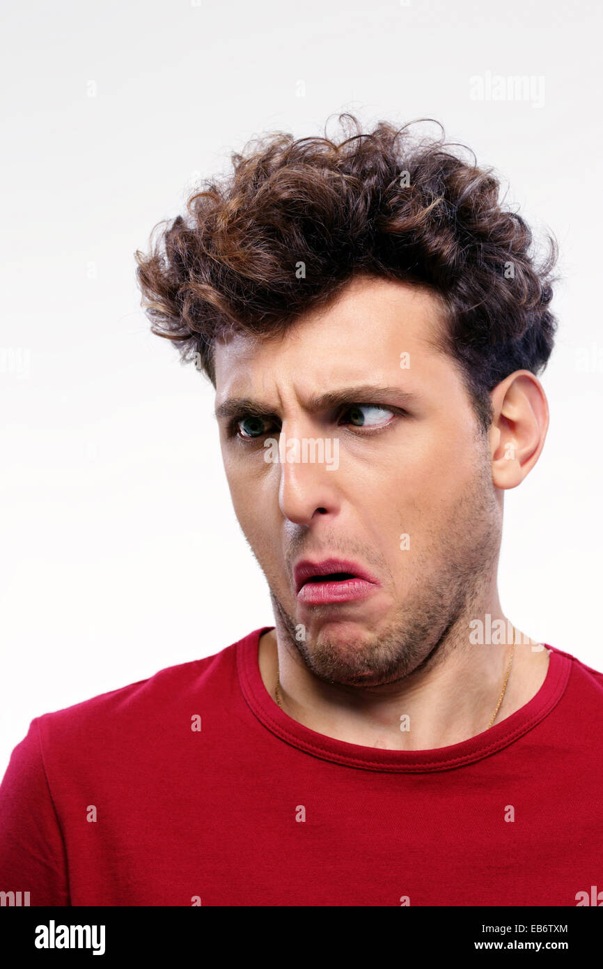 Young man with displeased facial expression Stock Photo - Alamy