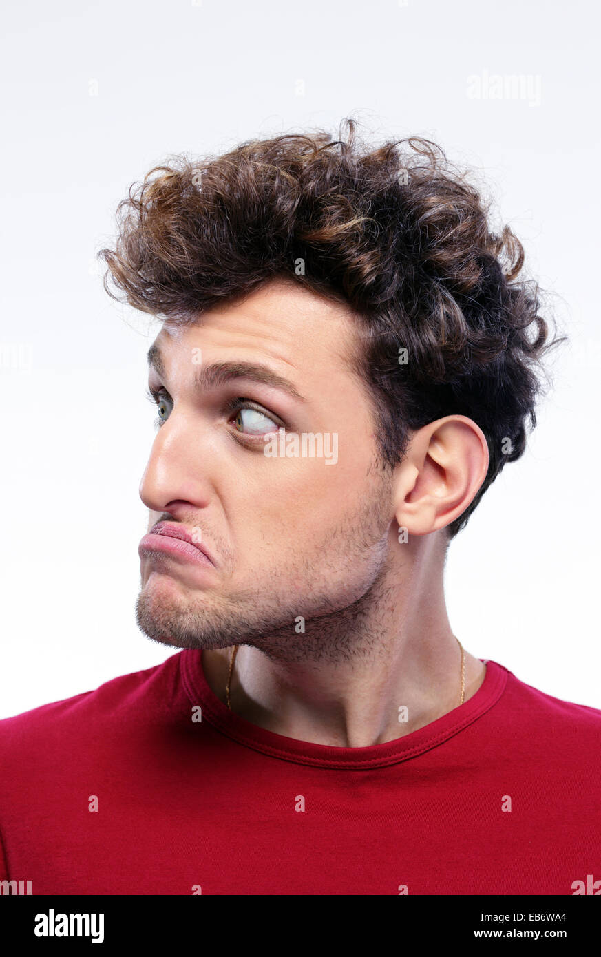 Surprised man looking away over gray background Stock Photo - Alamy