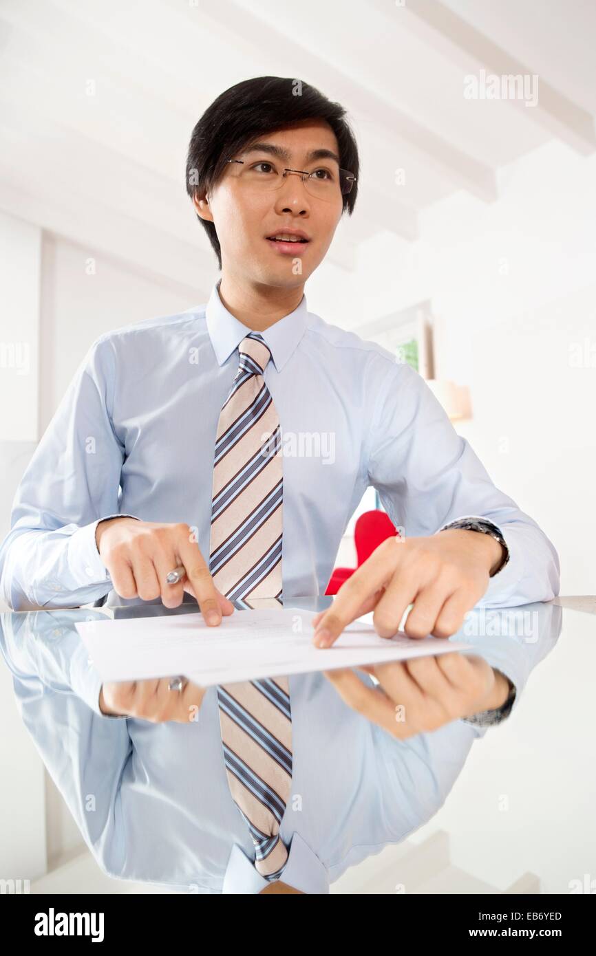 Young Asian businessman signing contracts Stock Photo - Alamy
