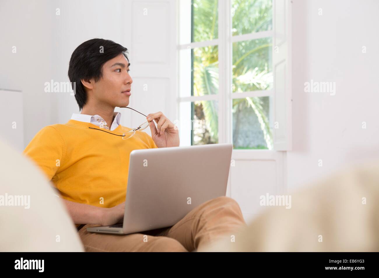 Young Asian man working on his laptop computer Stock Photo - Alamy