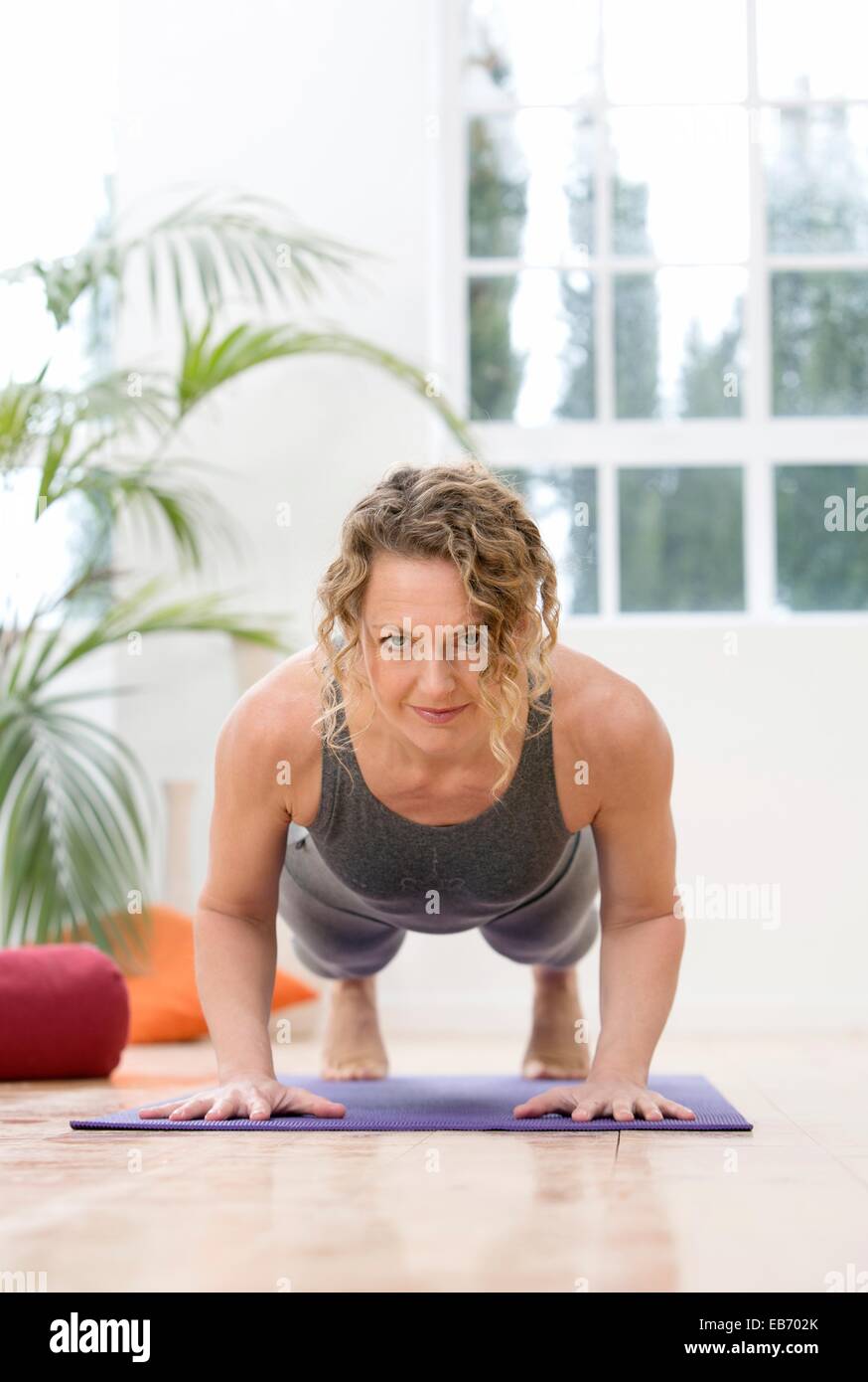 Healthy young woman doing the plank pose yoga position Stock Photo - Alamy