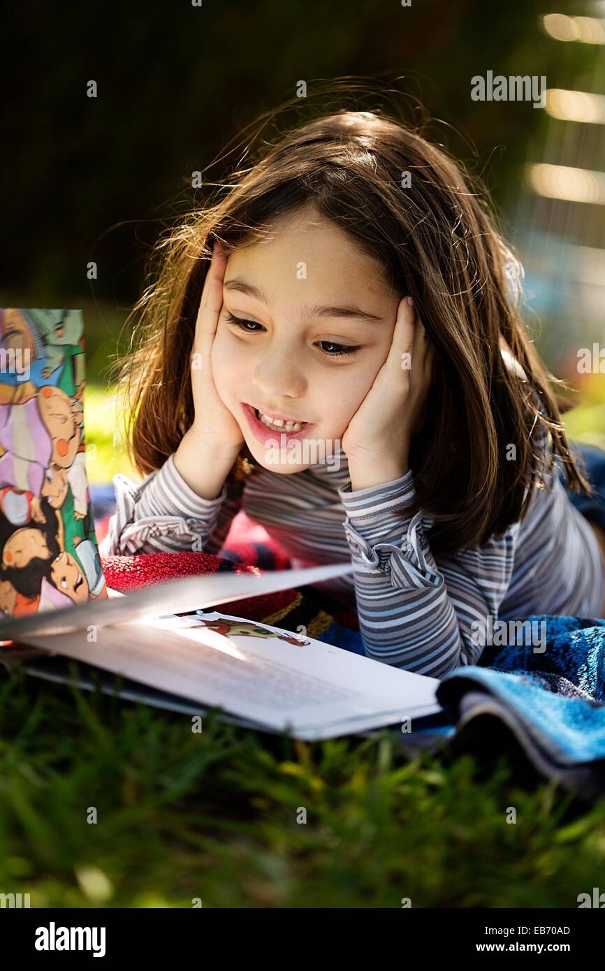 Girl reading a book on the grass Stock Photo - Alamy