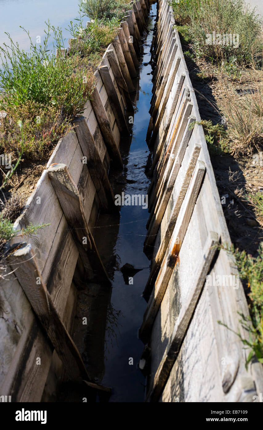Salt farm Irrigation Ditch, made with wooden boards Stock Photo - Alamy