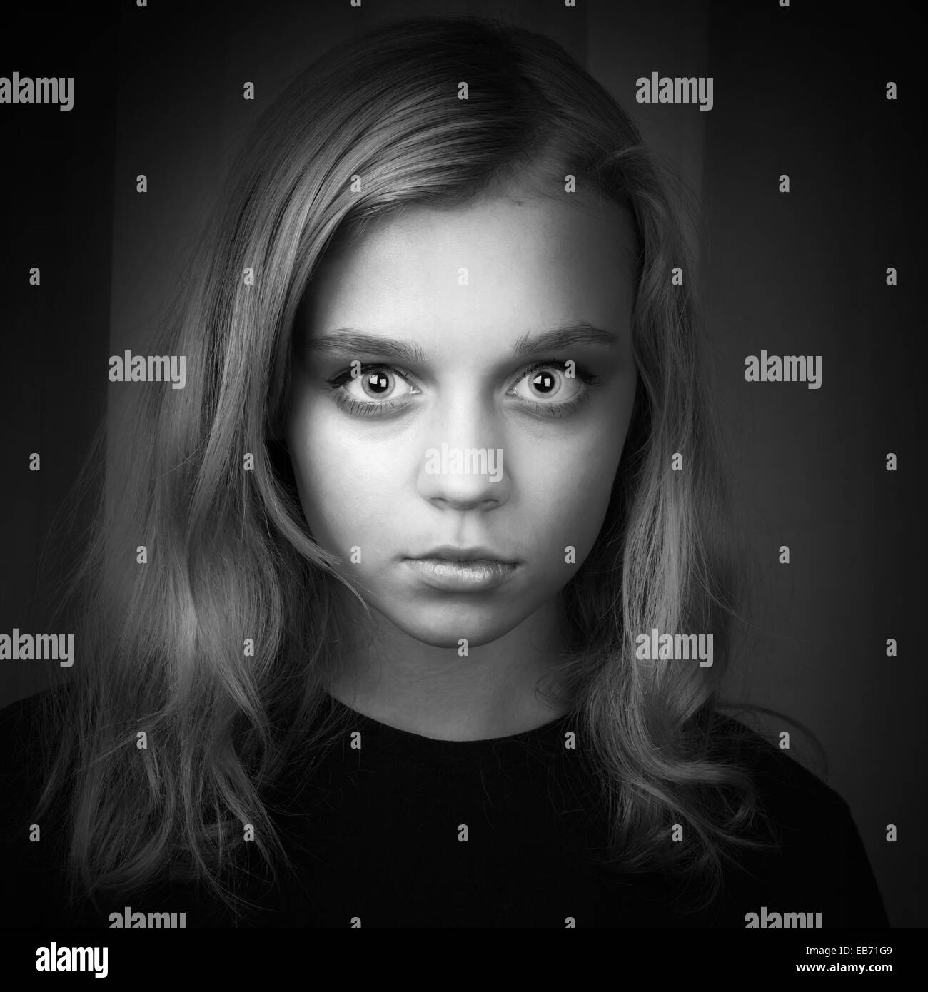 Serious blond Caucasian girl with mysterious hypnotic look Stock Photo ...