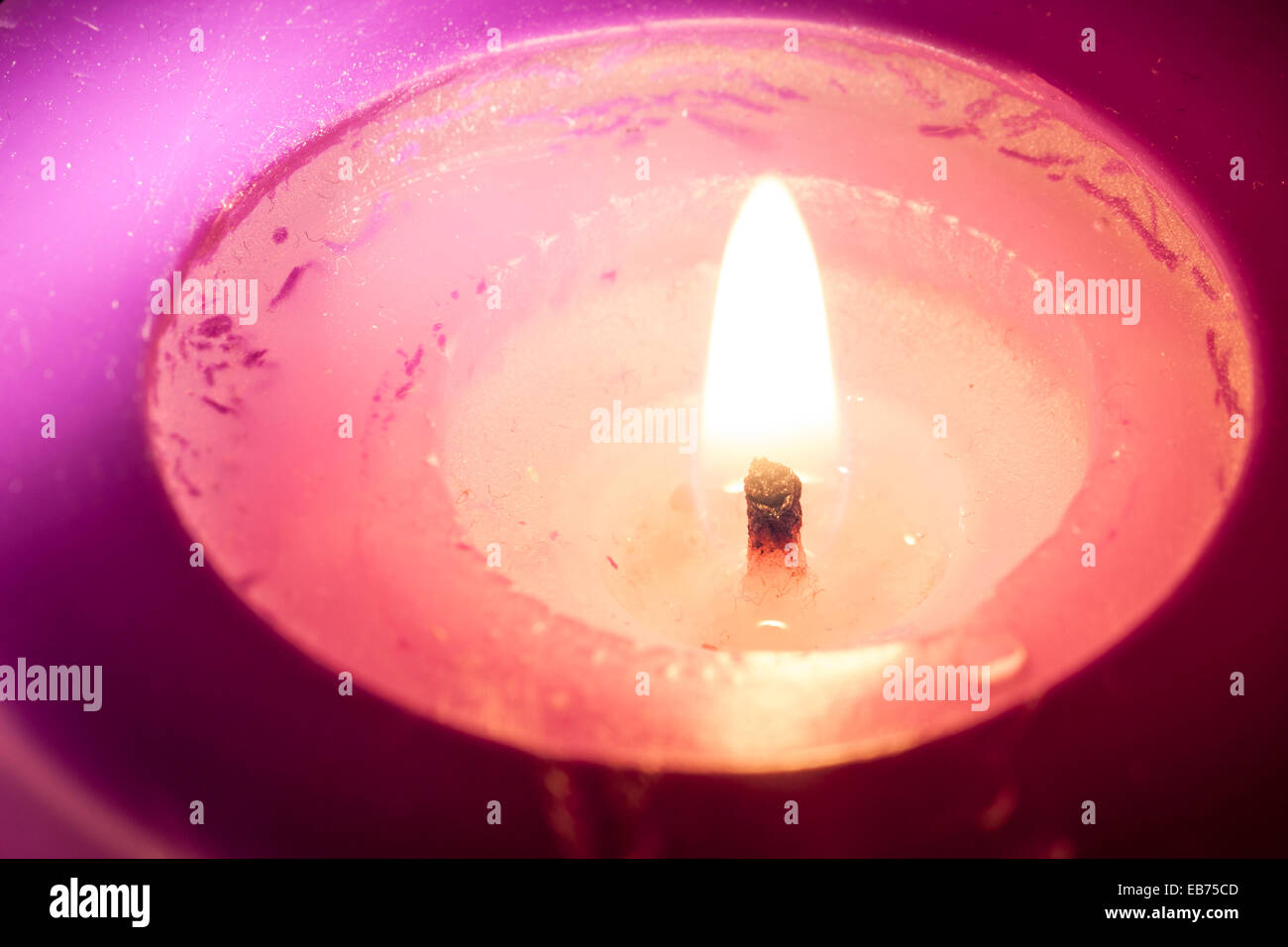 Macro view of a lit purple candle Stock Photo - Alamy