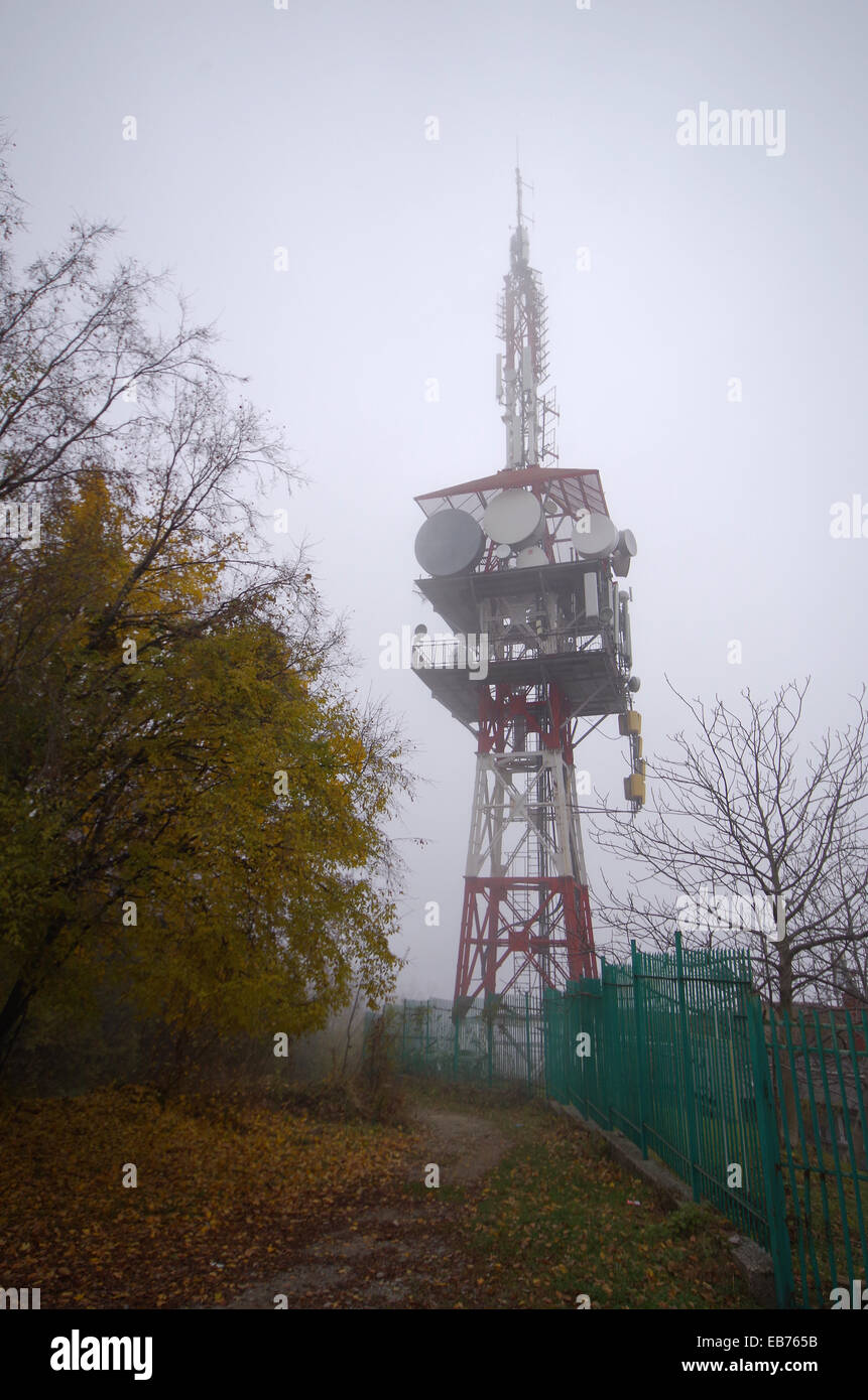 Telecommunications tower with many antennas in fog Stock Photo - Alamy
