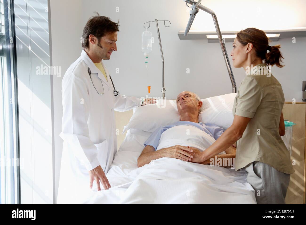 Patient attending to senior hospital hi-res stock photography and ...