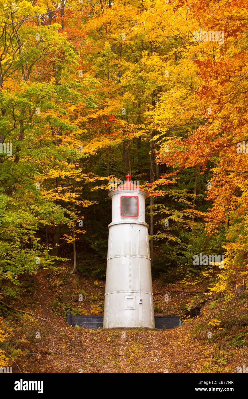 A hillside lighthouse beacon with fall foliage color in Munising ...