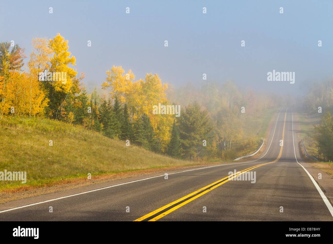 Highway 13 with fall foliage color and fog in northern Wisconsin, USA ...