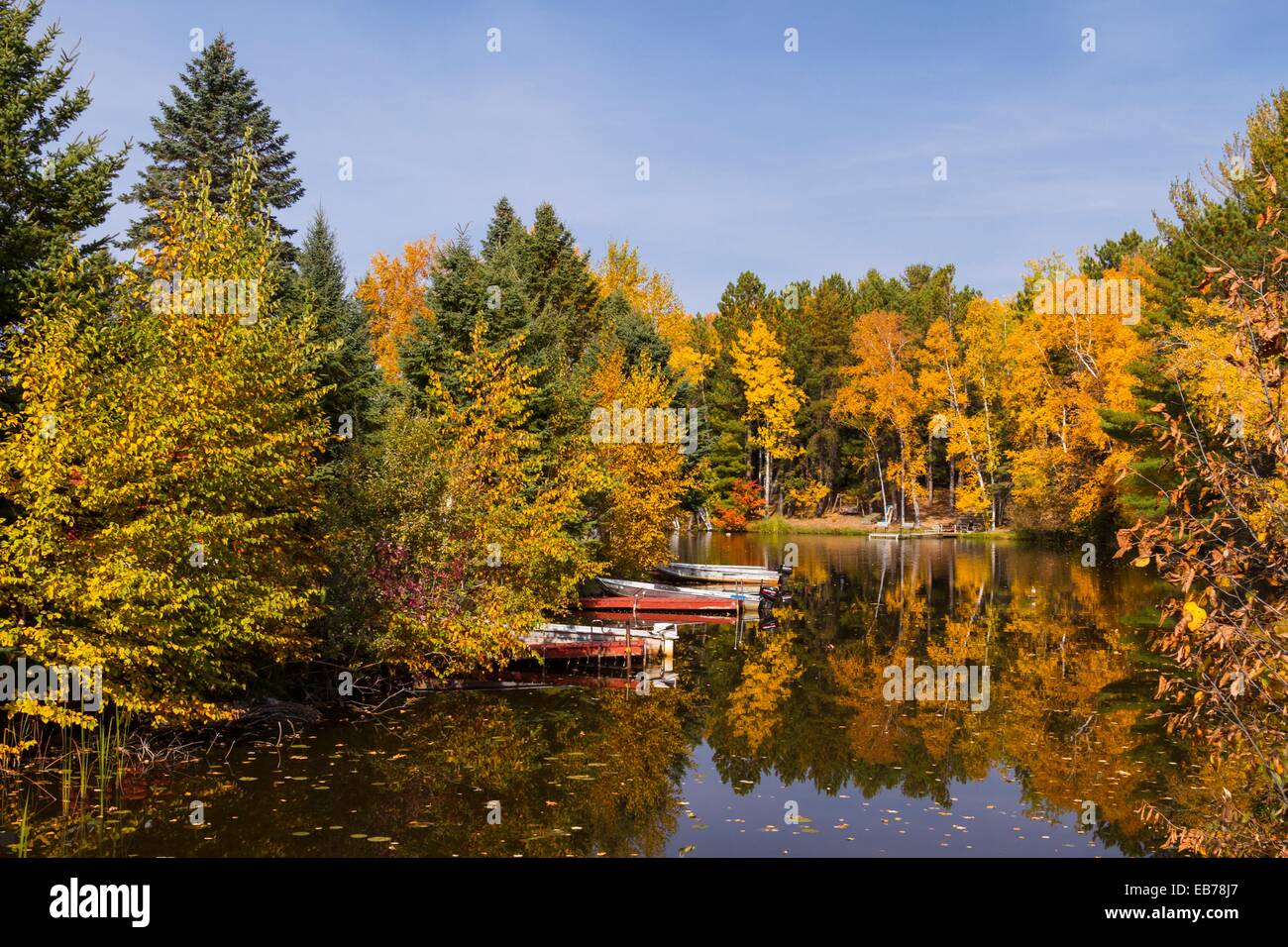 Reflections of fall foliage color in a small lake in northern Wisconsin ...