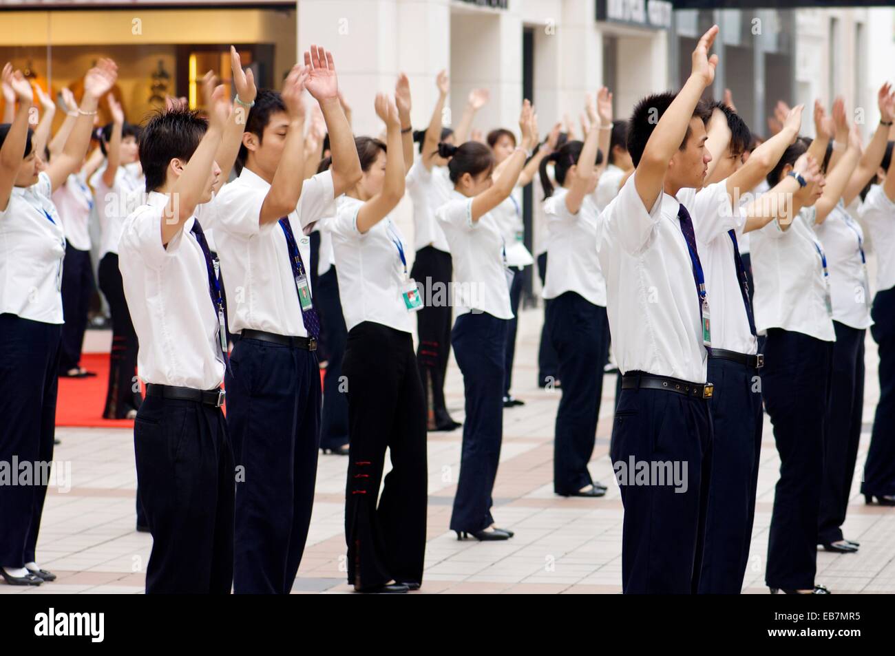 A department store workers perform exercises before starting their ...