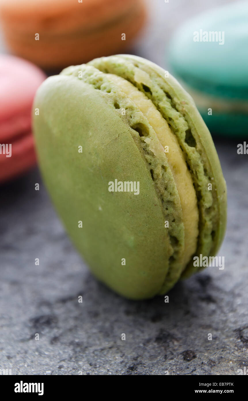 Single sweet macaroon biscuit over gray stone Stock Photo - Alamy