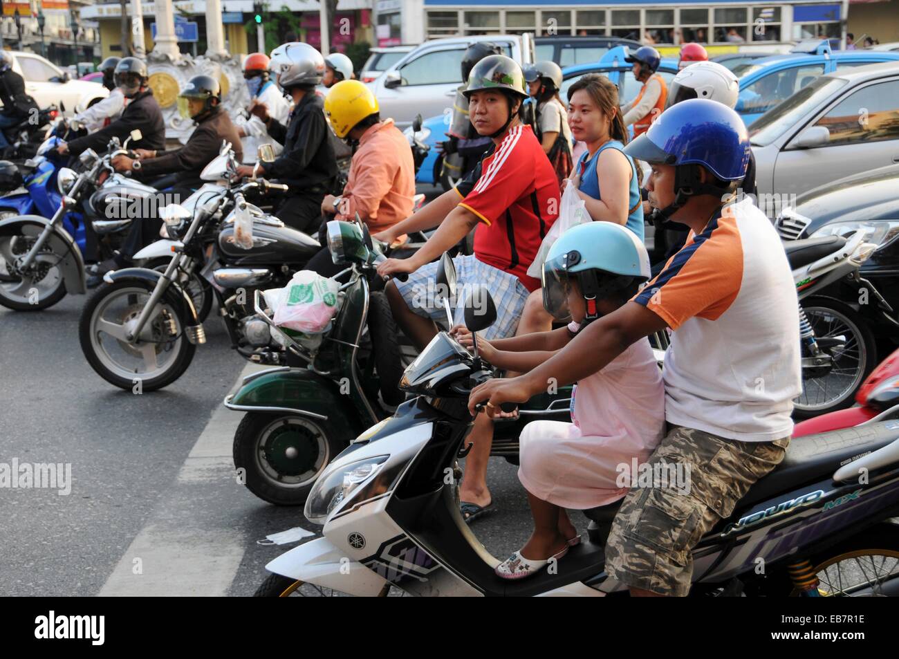 Scooter riders waiting at a traffic light in Bangkok Stock Photo - Alamy