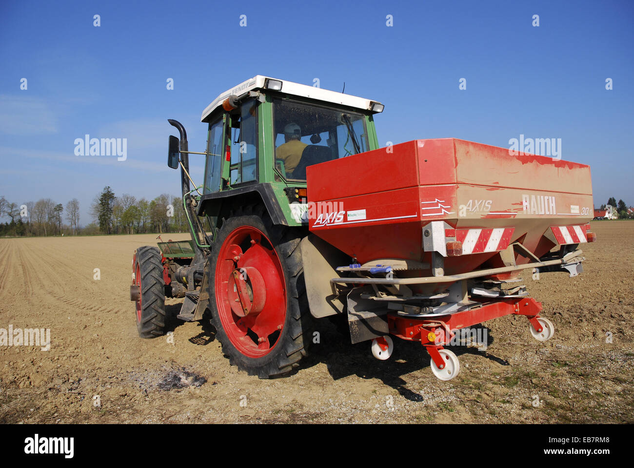 Farmer sows fertilizer Stock Photo - Alamy