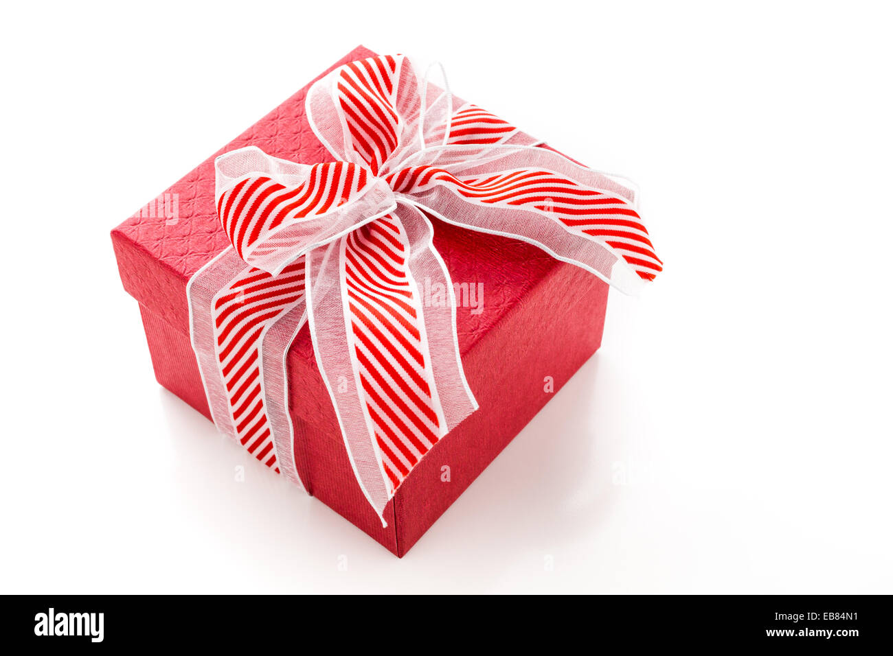 Christmas present wrapped in the box with red and white ribbon Stock ...