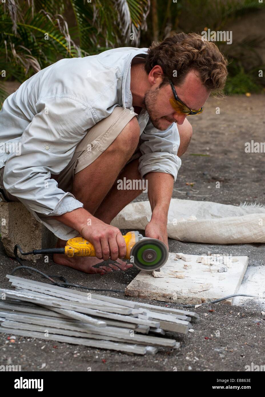 Man cutting tile Stock Photo - Alamy