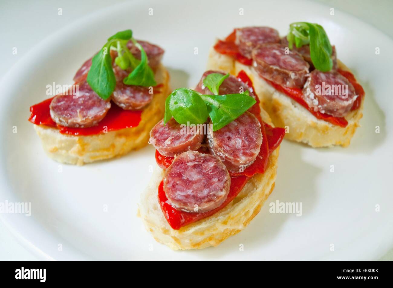 Spanish tapa: Fuet with red pepper. Close view Stock Photo - Alamy