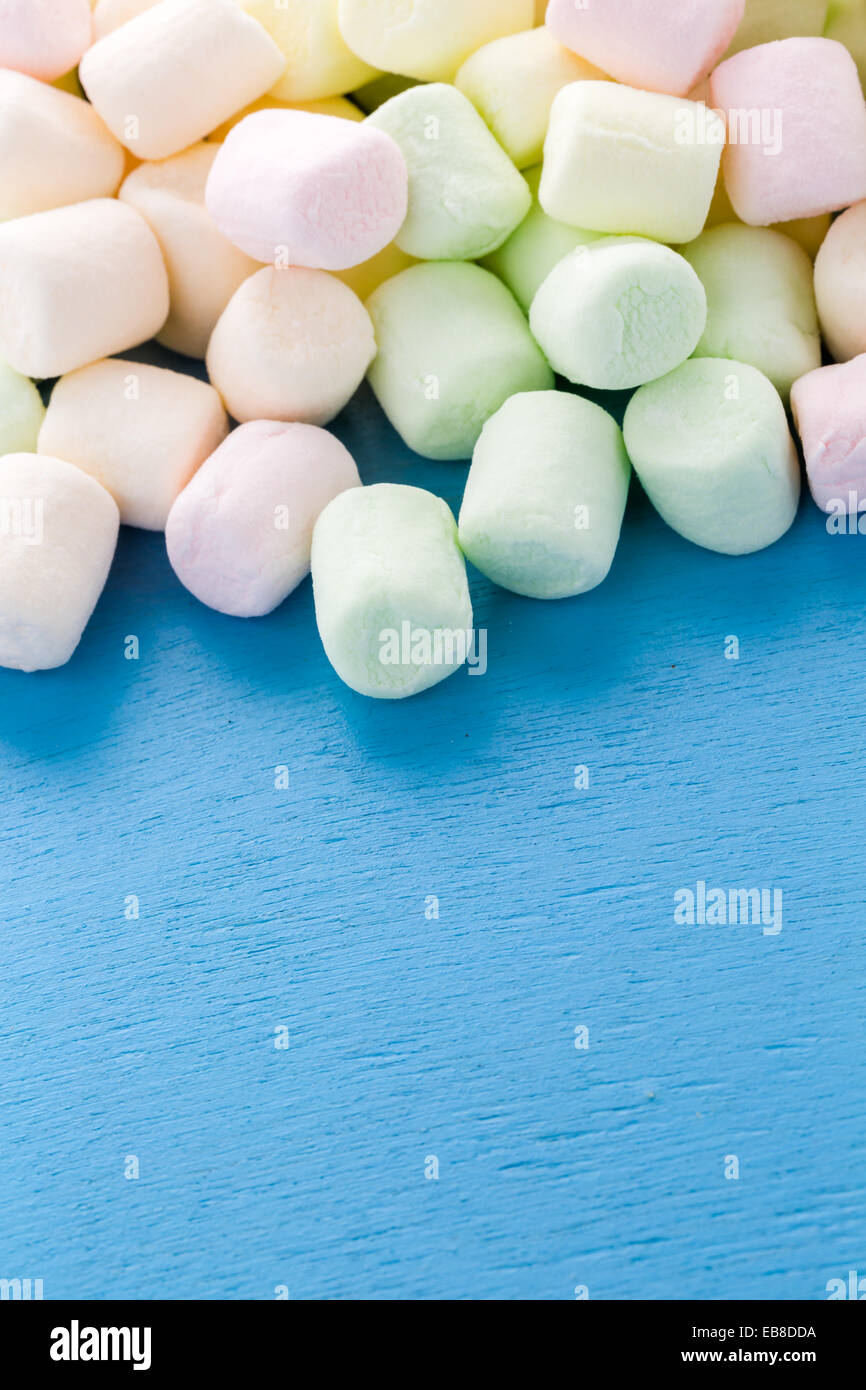 Small round multicolor marshmallows on blue backgrouns Stock Photo - Alamy