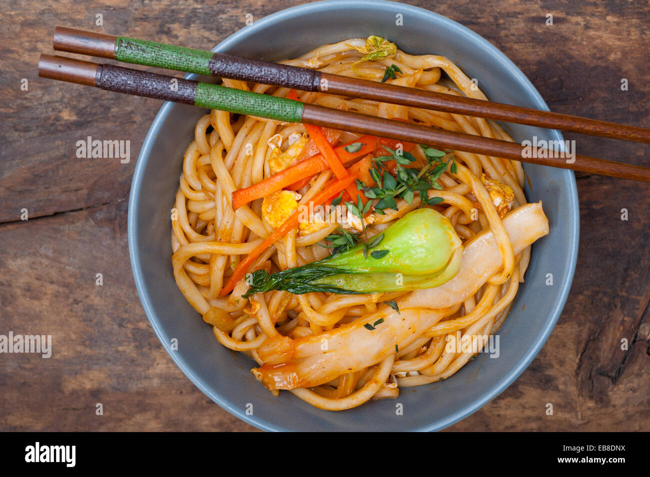 hand pulled stretched Chinese ramen noodles on a bowl with chopstick ...