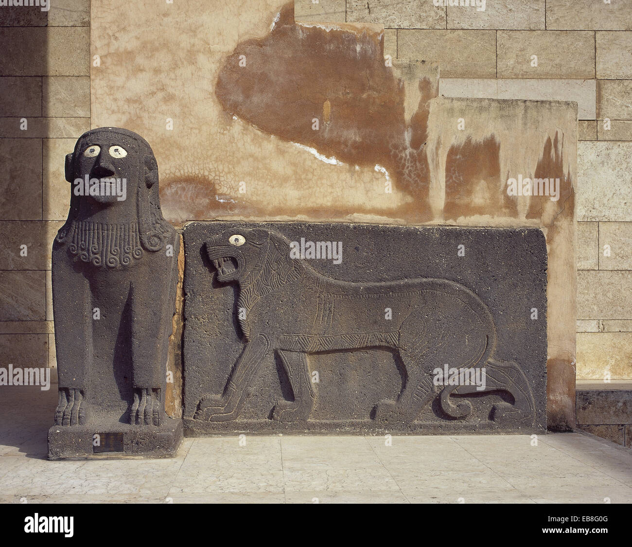 Sphinx and a lion in relief. Basalt. Guarding the temple of Tell Halaf ...