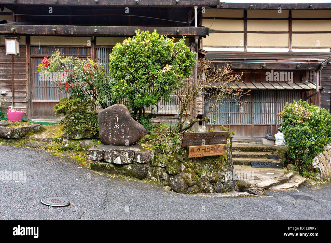 Inscribed rock and wooden direction signs outside 2 traditional Edo ...