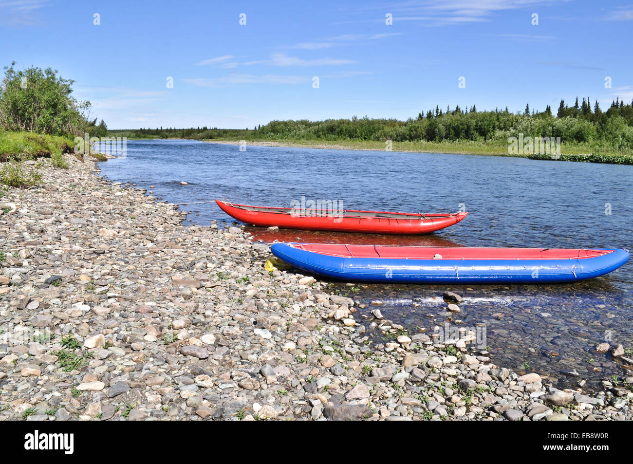 Two inflatable canoes on the shore of the North river. Polar Ural, Komi ...