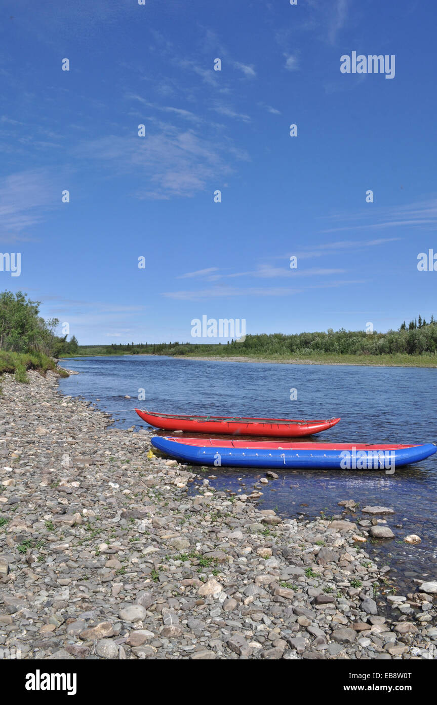 Two inflatable canoes on the shore of the North river. Polar Ural, Komi ...