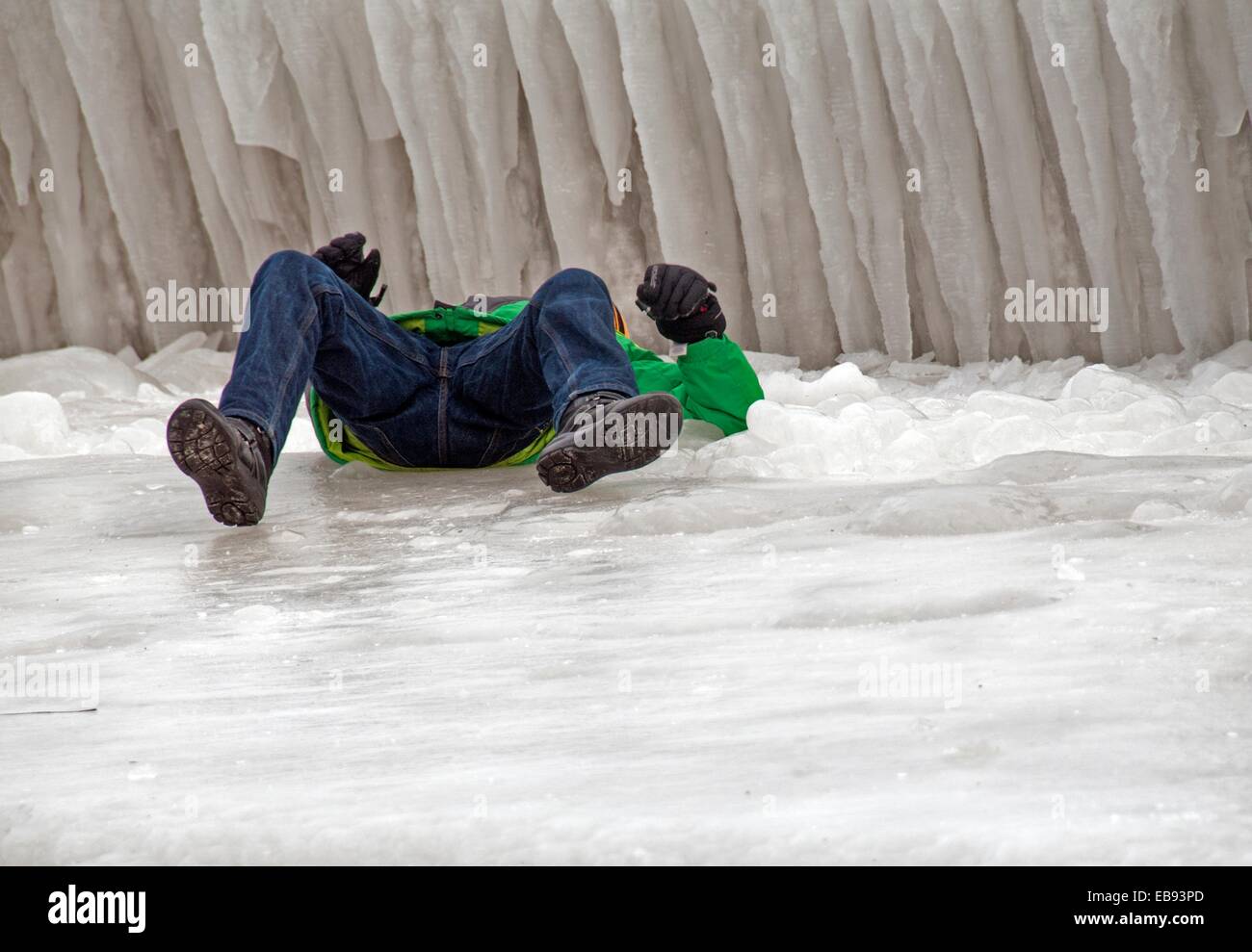 single boy laying on covered with ice street, heavy winter, Versoix ...