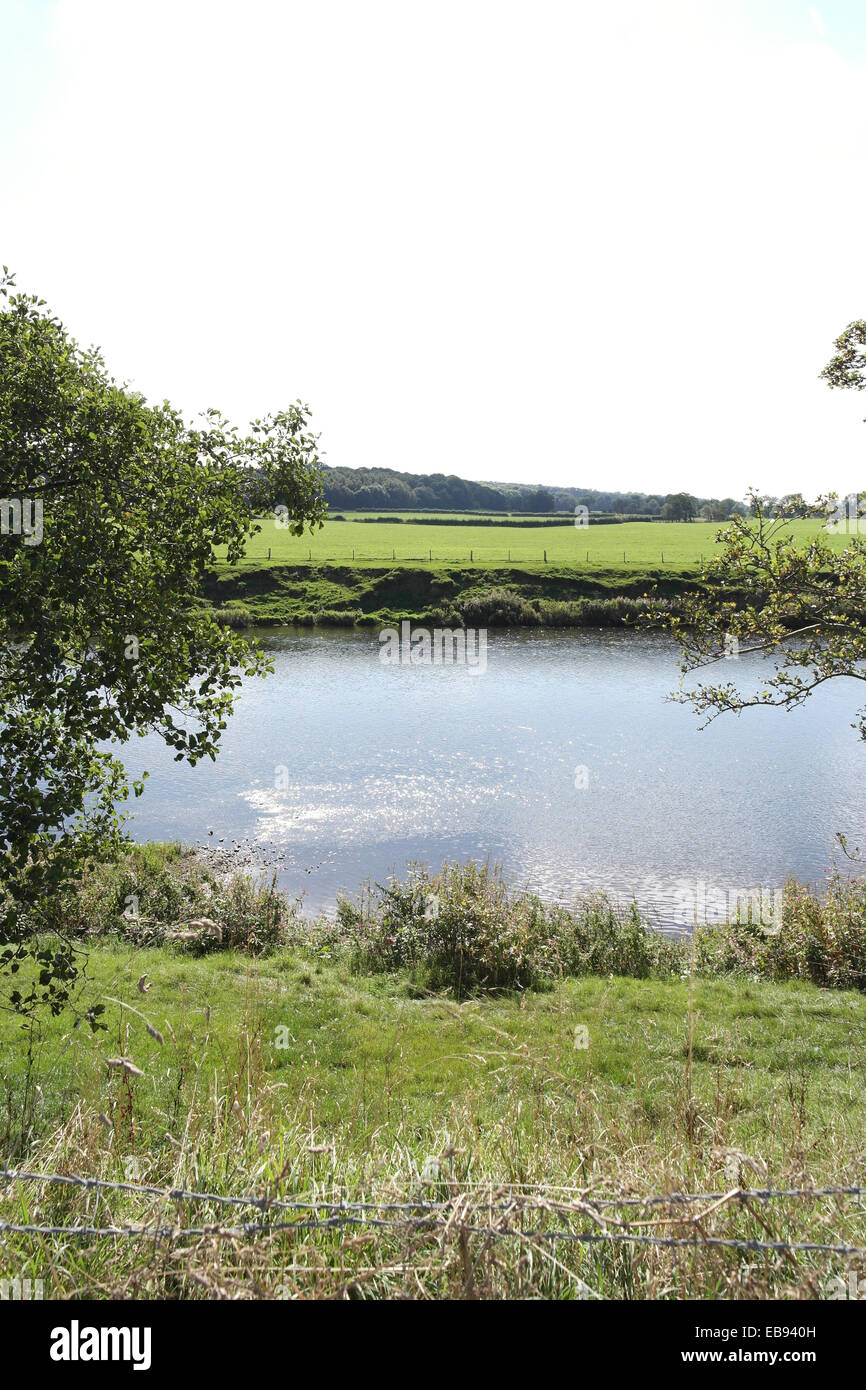 Sunny portrait, looking south, blue water River Ribble, with white ...