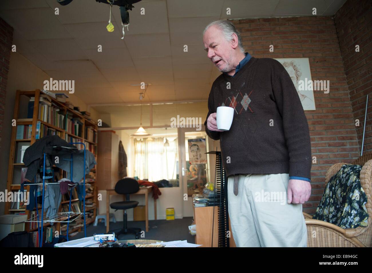 Rotterdam, Netherlands. Older man in his disorganized living-room Stock ...