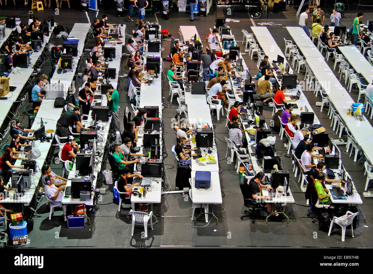 Participants of a Aviles computer party , sitting in front of computers ...