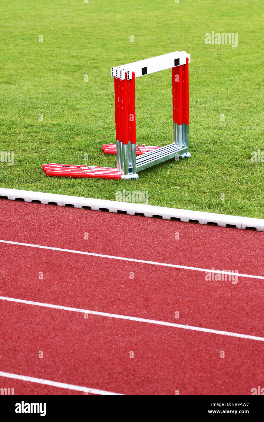 Track and hurdles on the green lawn Stock Photo - Alamy