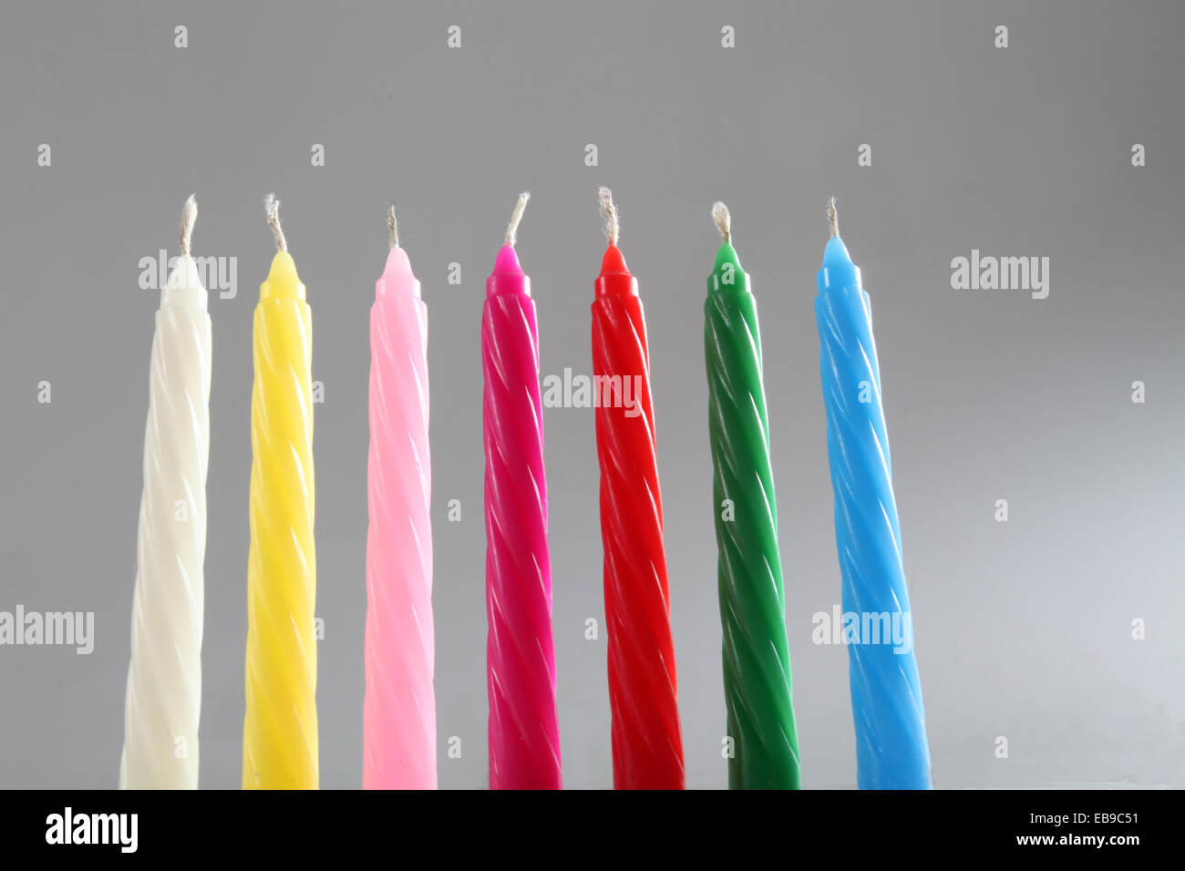 seven birthday candles on neutral background Stock Photo - Alamy