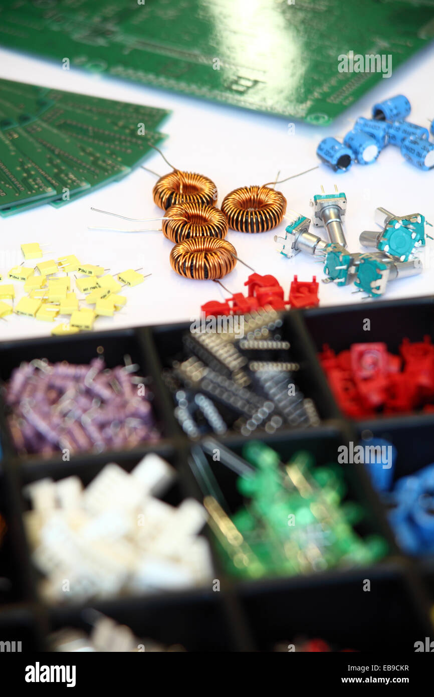 box with assortment of electronic components on a white background ...