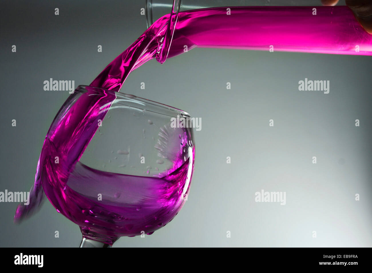 Pink cocktail splash, glass with spilled liquid Stock Photo - Alamy