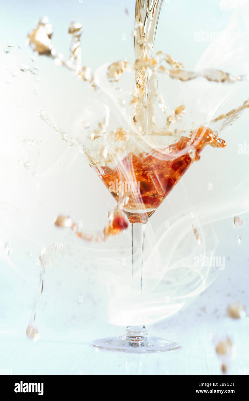 cocktail splash, glass with spilled liquid, and smoke Stock Photo - Alamy