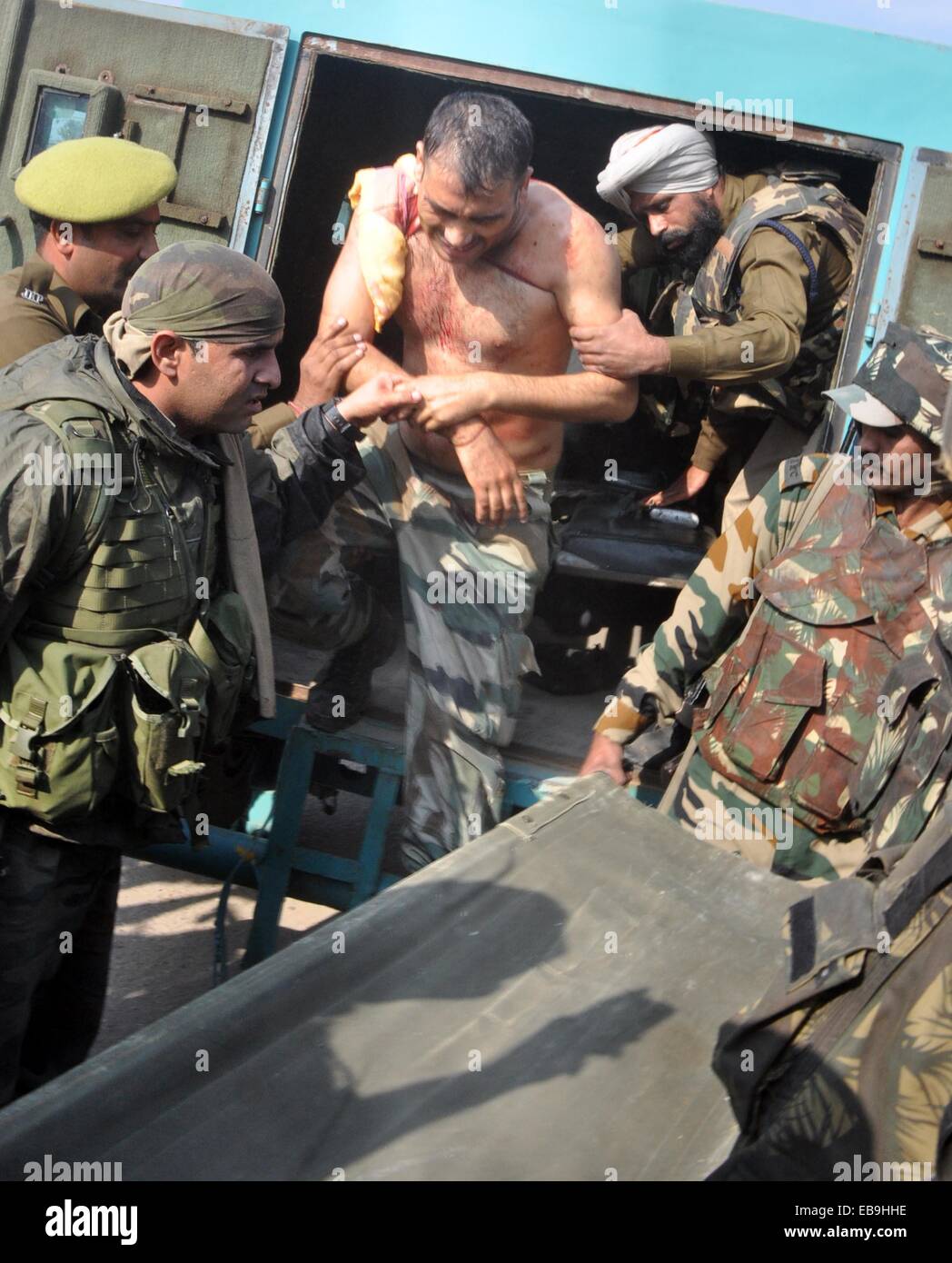 Indian army men shift a soldier injured in the ongoing encounter ...