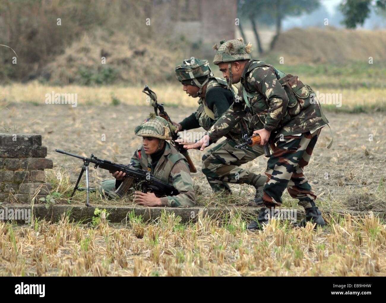 Indian Army soldiers take positions during the ongoing encounter ...