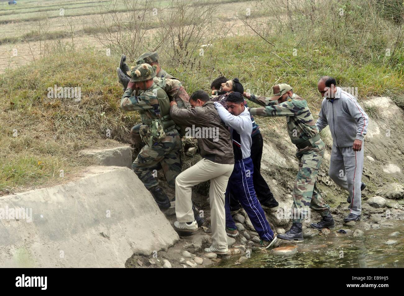 Indian Army soldiers and locals help evacuate a fatally wounded Soldier ...