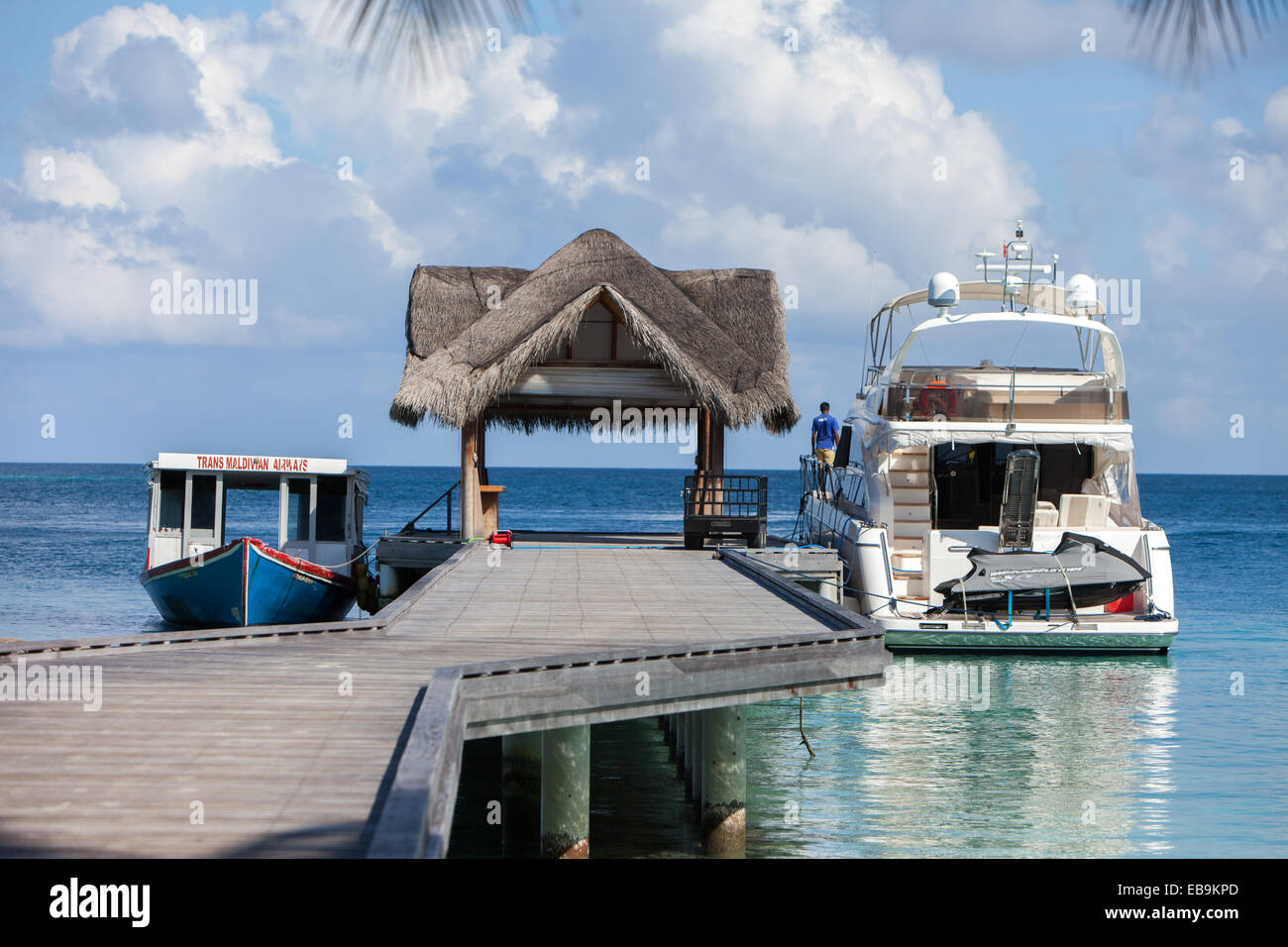 Boats tied up alongside a wooden jetty on a Maldivian Holiday Island ...