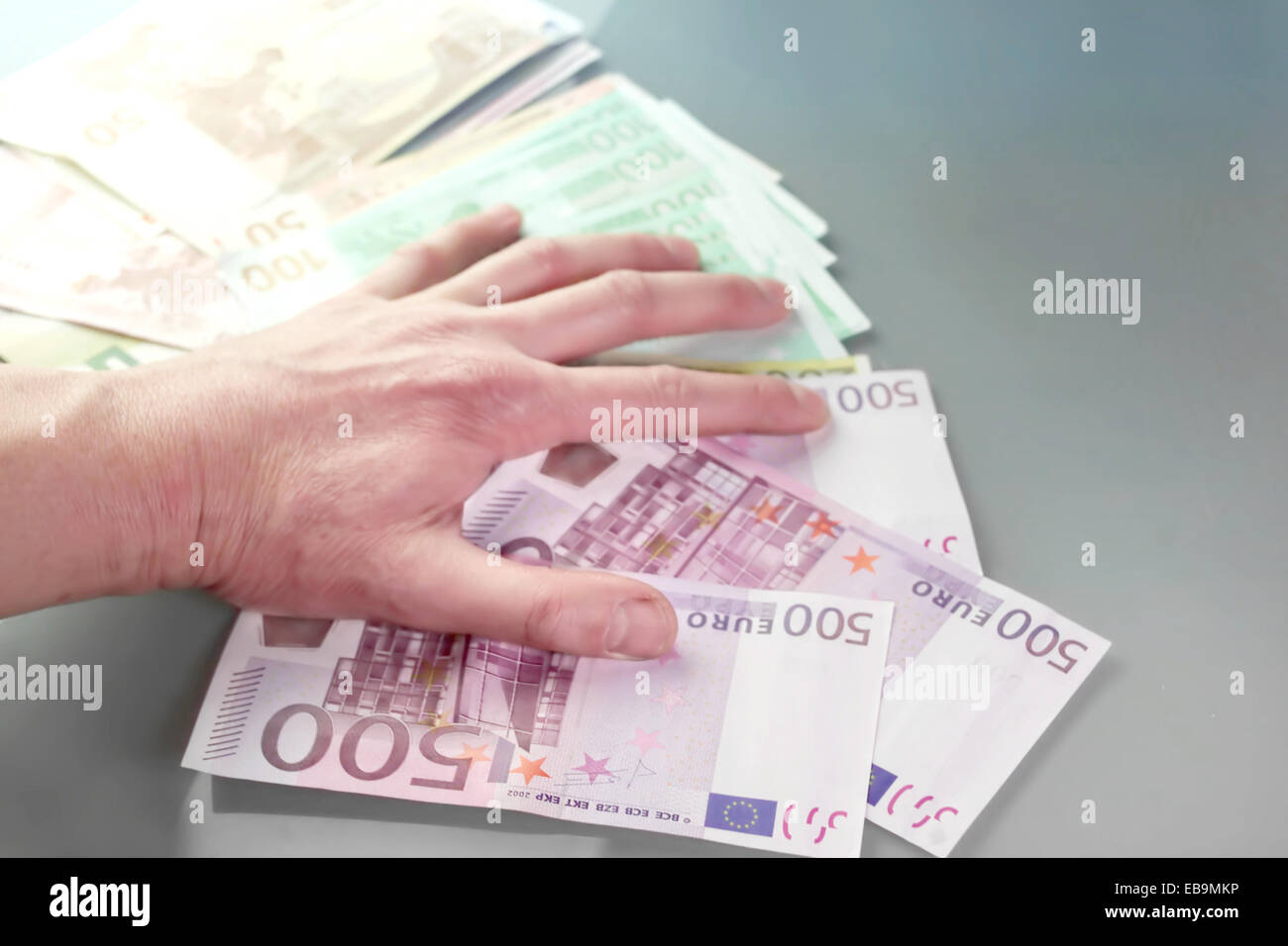 Hand grabbing money hi-res stock photography and images - Alamy