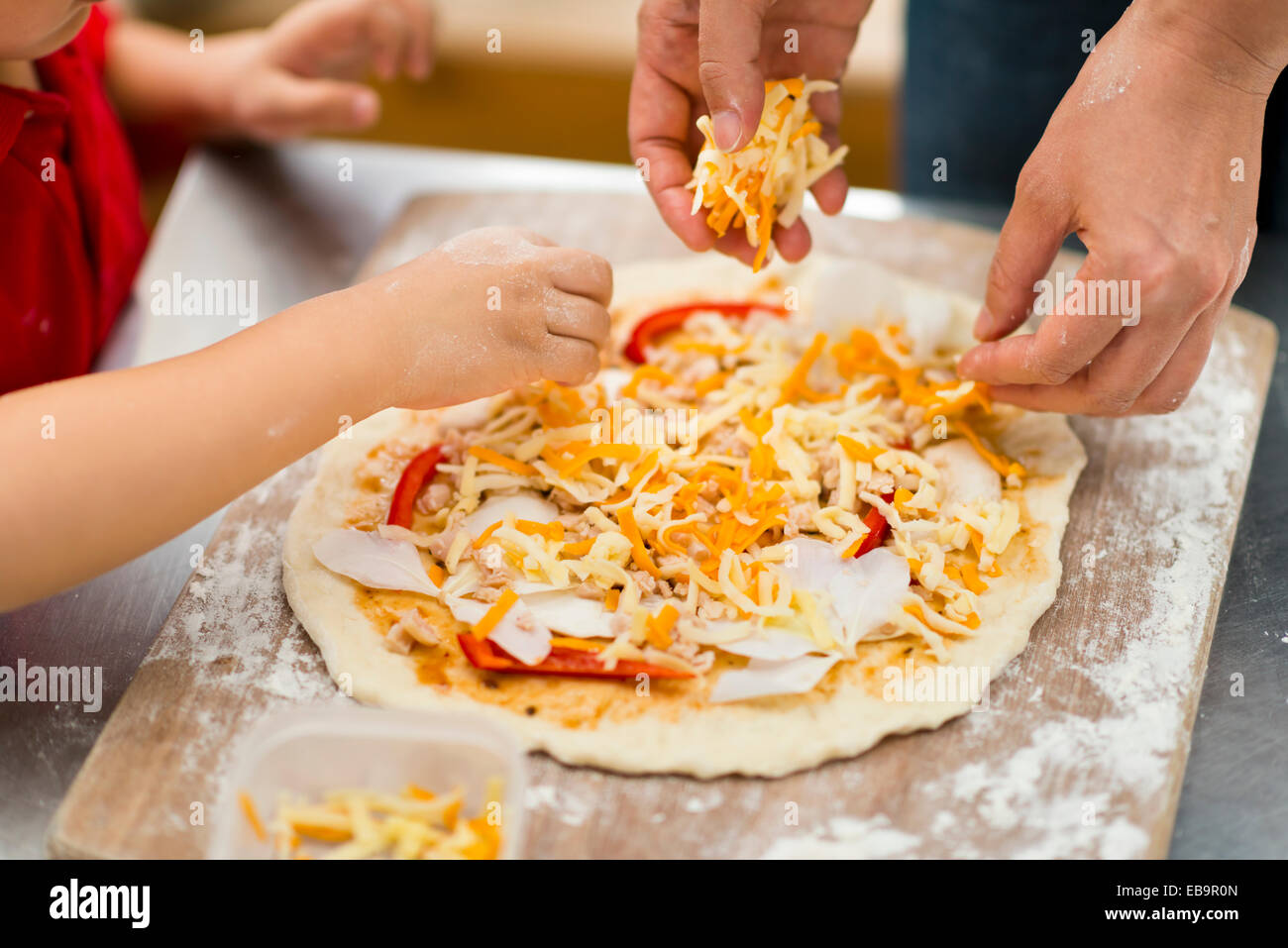 Child and mother making pizza Stock Photo - Alamy