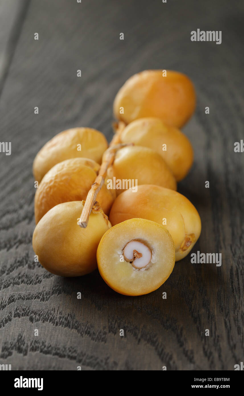 fresh raw dates on table, old oak wood Stock Photo - Alamy