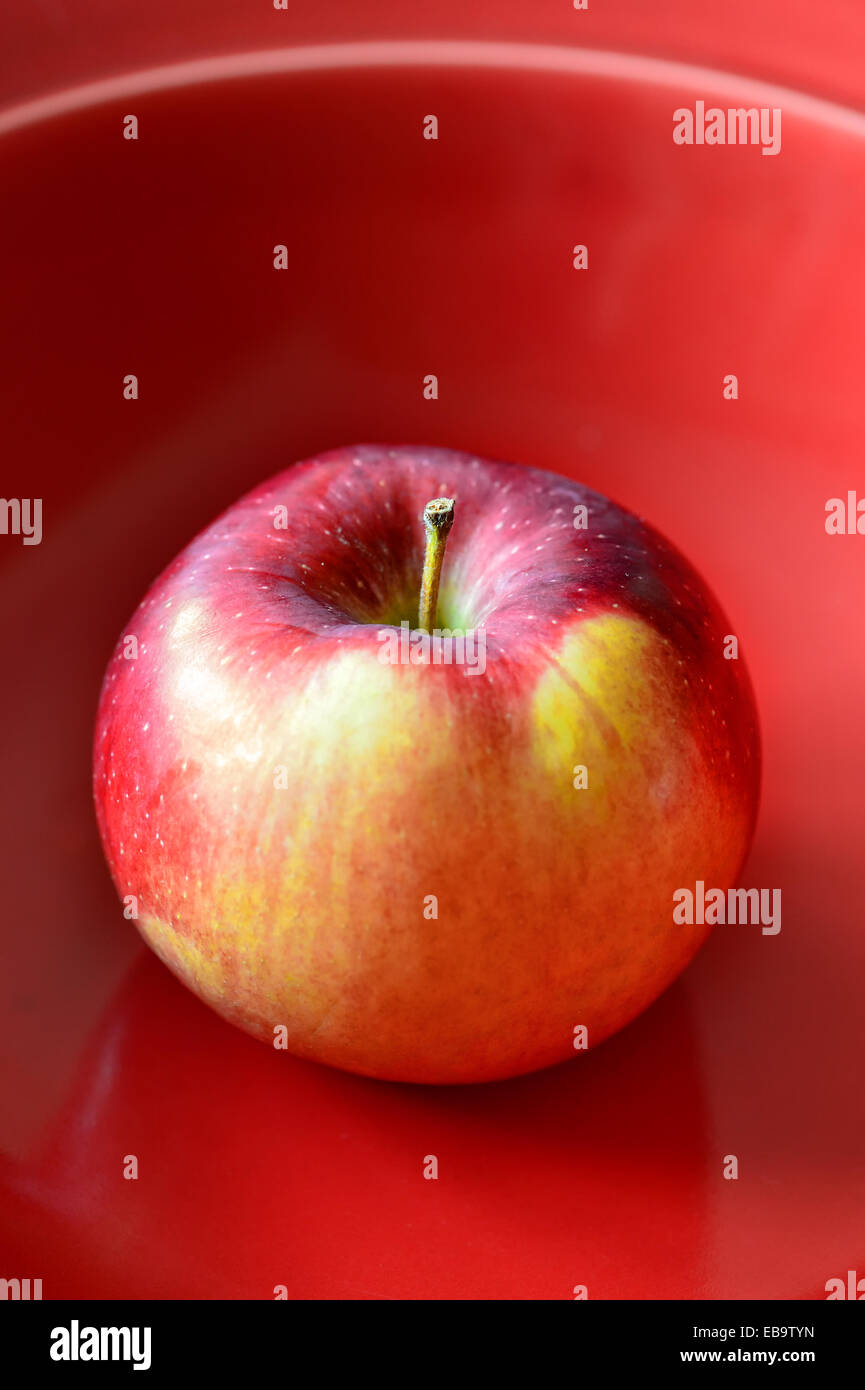 Apple in red bowl Stock Photo - Alamy