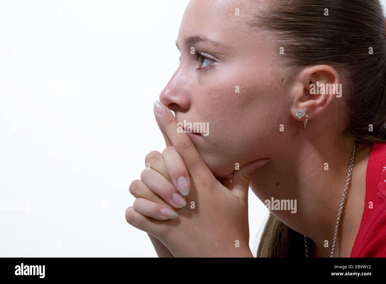 Teenage girl looking thoughtful Stock Photo - Alamy