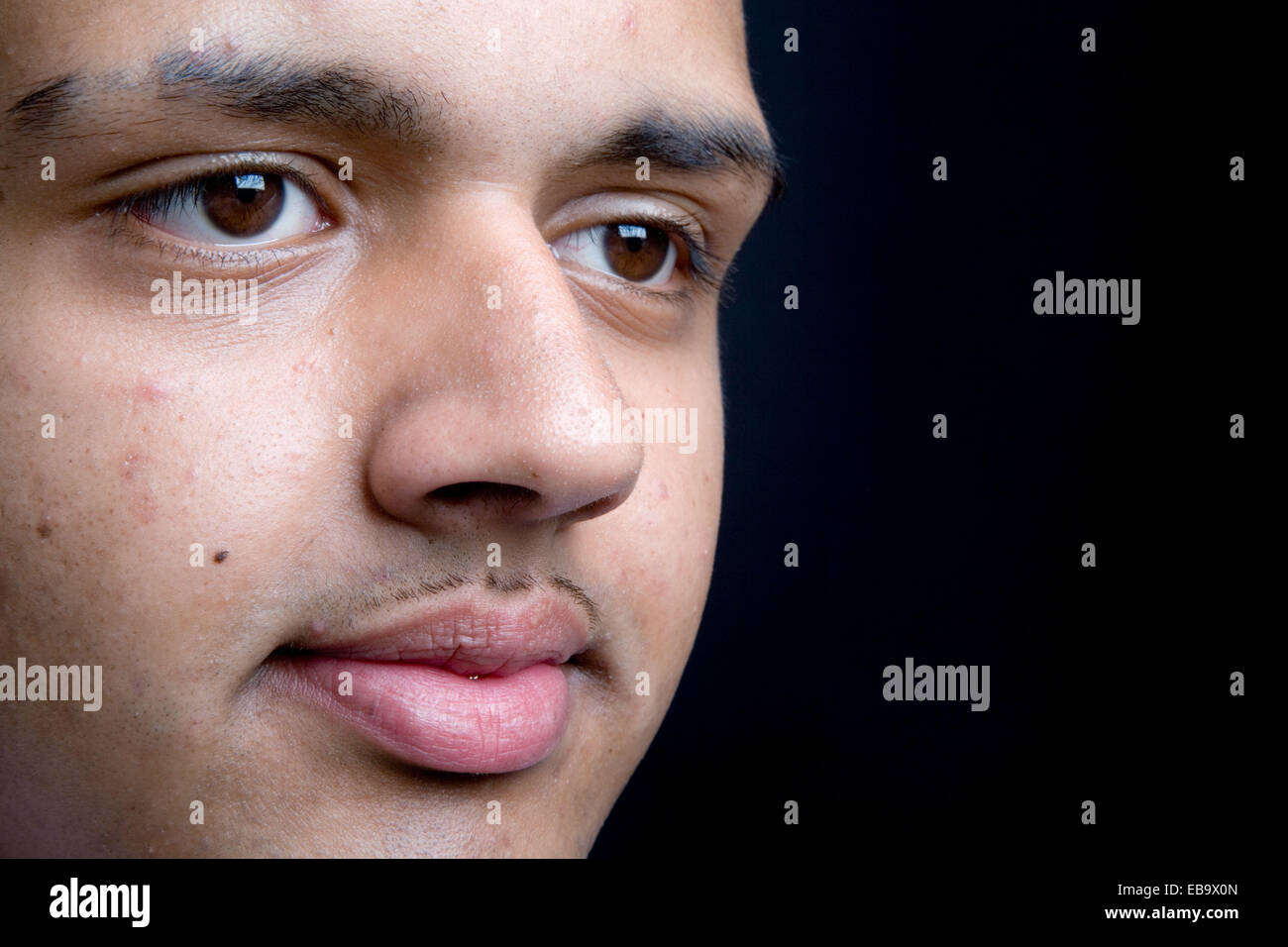 Teenage boy looking serious Stock Photo - Alamy