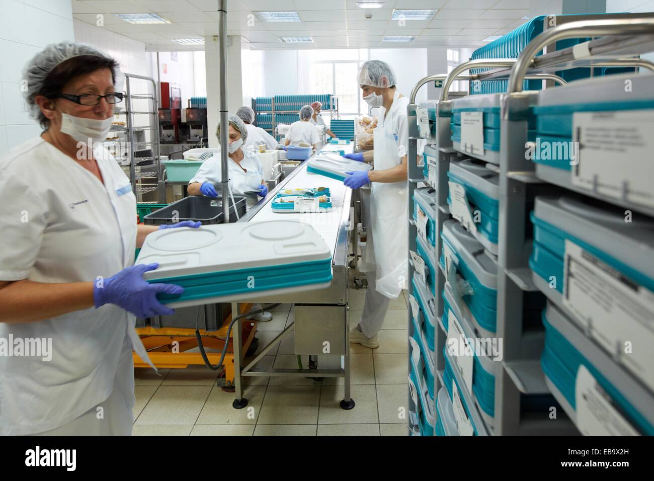 Woman in kitchen carrying tray hi-res stock photography and images - Alamy