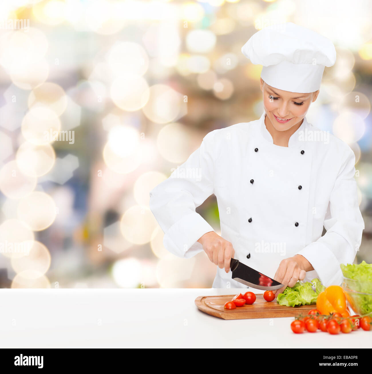 smiling female chef chopping vegetables Stock Photo - Alamy