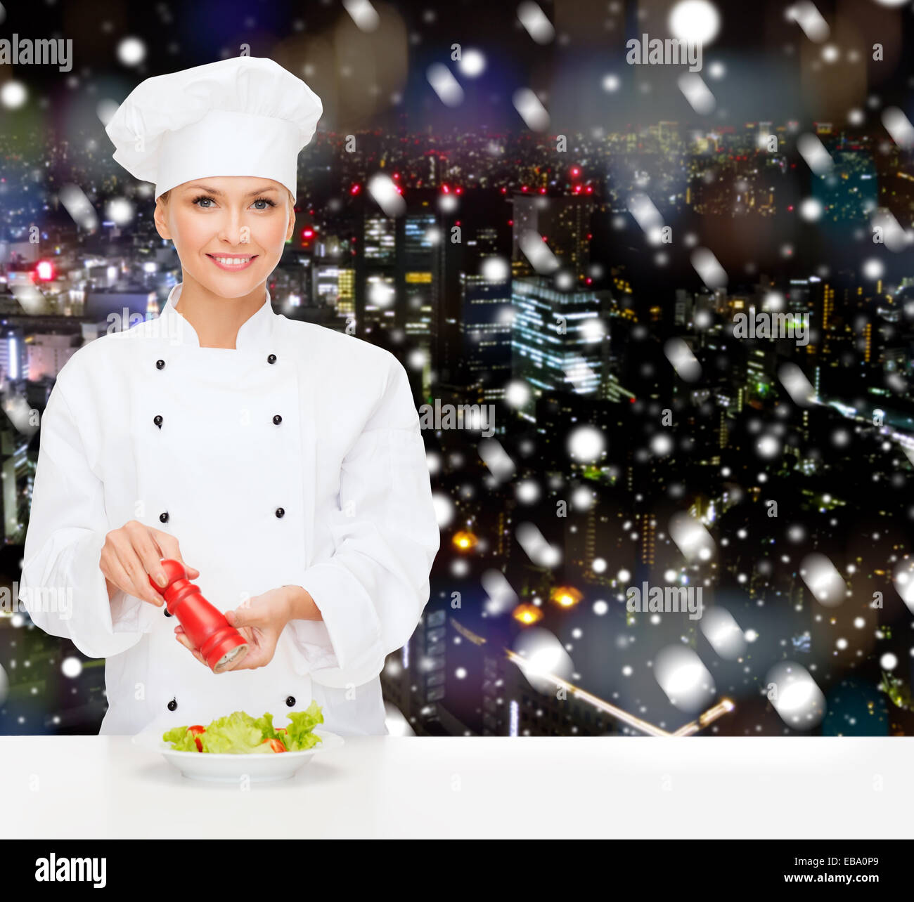 smiling female chef spicing vegetable salad Stock Photo - Alamy