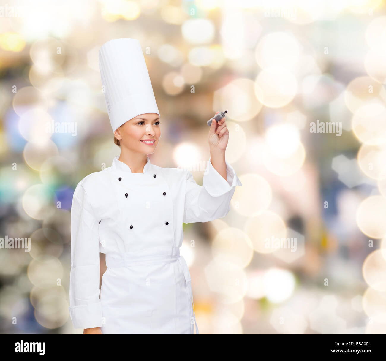 smiling female chef writing something on air Stock Photo - Alamy